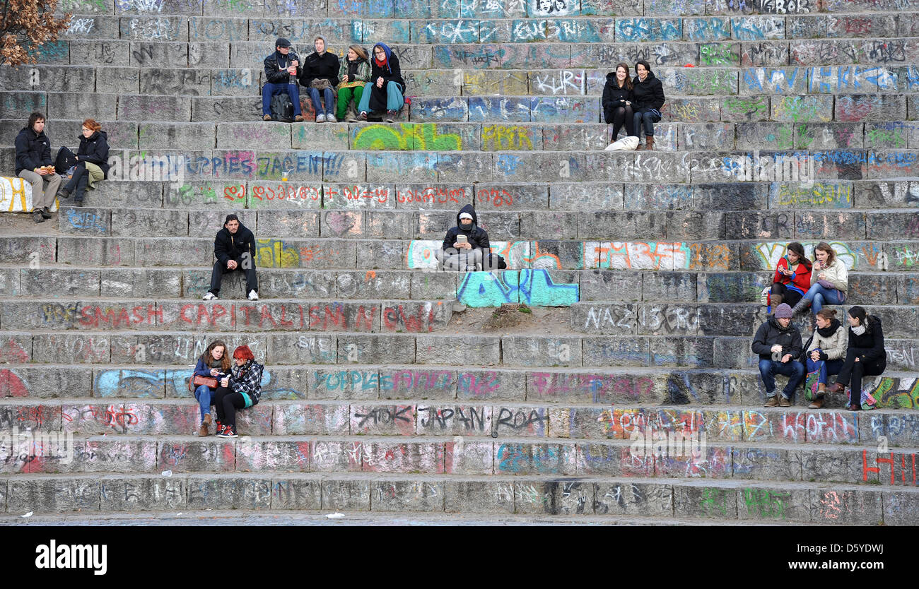 People sit on the steps of the small amphitheatre in the Mauerpark in ...