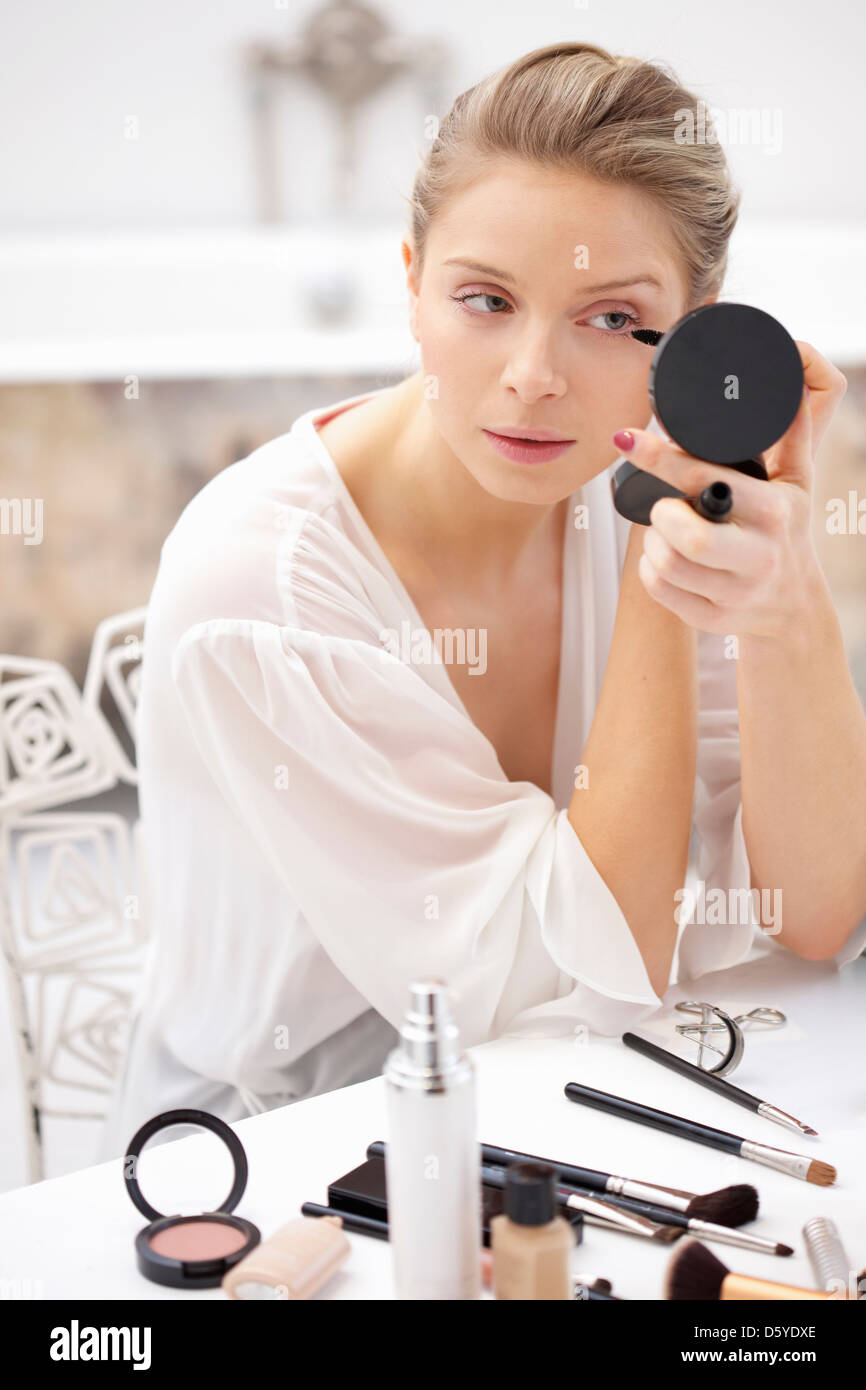 Applying makeup in compact mirror hi-res stock photography and images ...