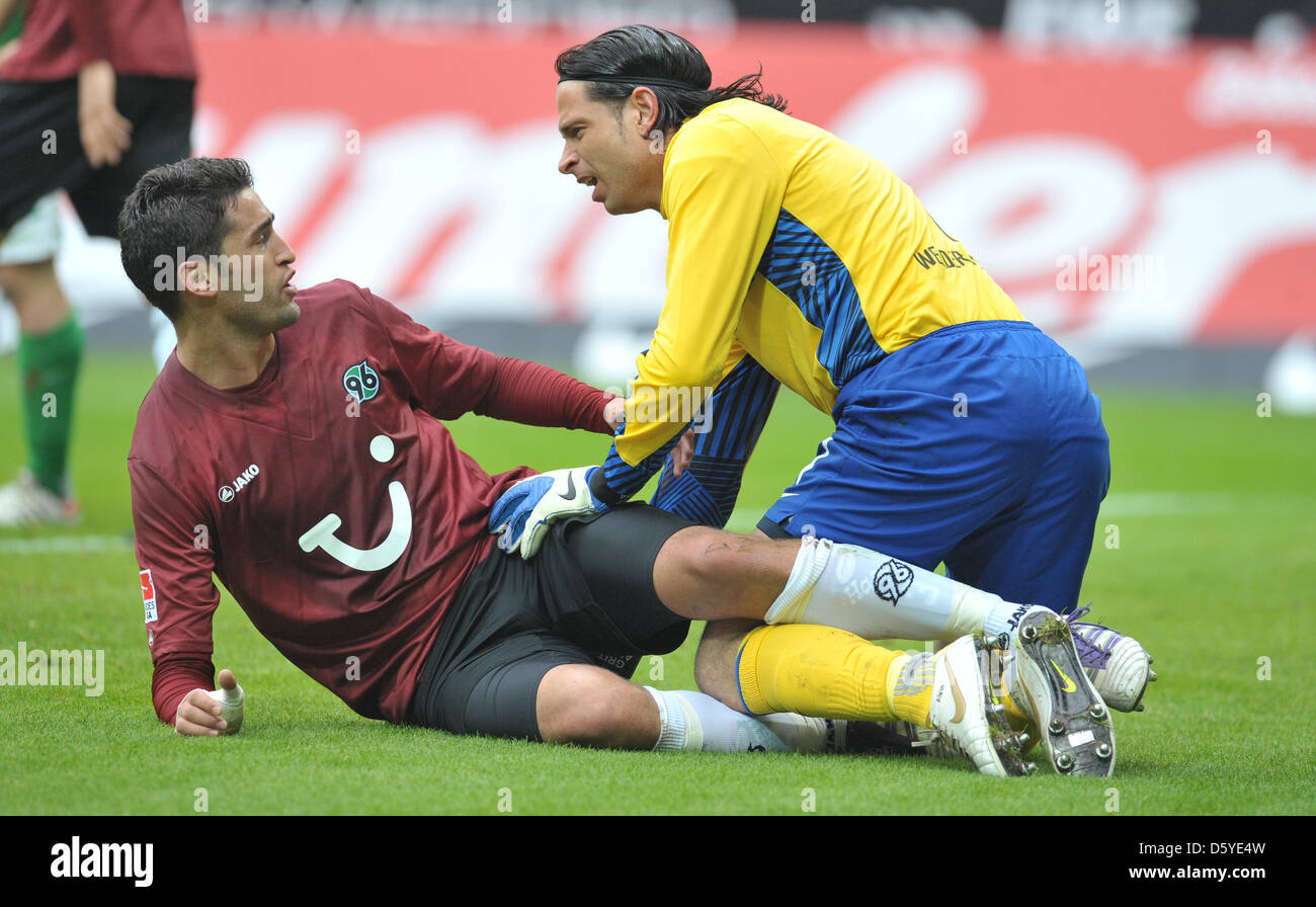 Bremen's goalkeeper Tim Wiese collides with Hanover's Karim Haggui ...