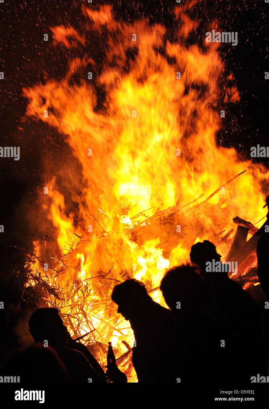 People stand in front of a large bonfire in Wuelfinghausen, Germany, 07 ...