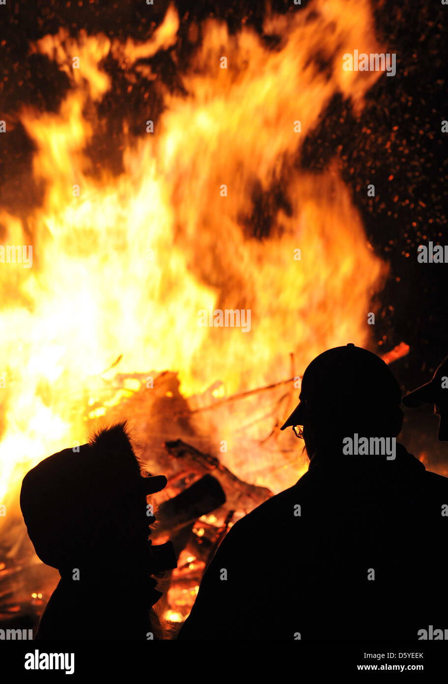 People stand in front of a large bonfire in Wuelfinghausen, Germany, 07 ...