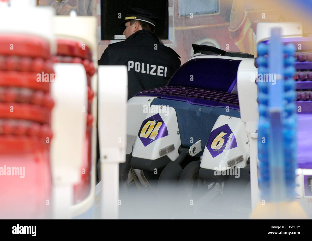 Police officers investigate at a detached car of amusement ride ...