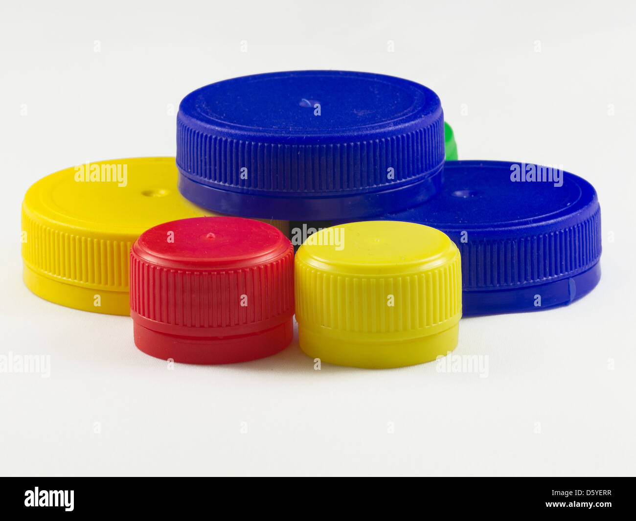 Bunch of multicolored used plastic bottle caps on white background ...