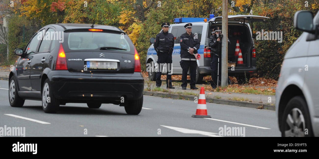 Police officers use a laser speed measuring device in Hanover, Germany ...