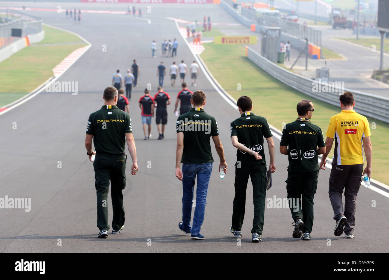 Formular One drivers and the team members walk around the race track ...