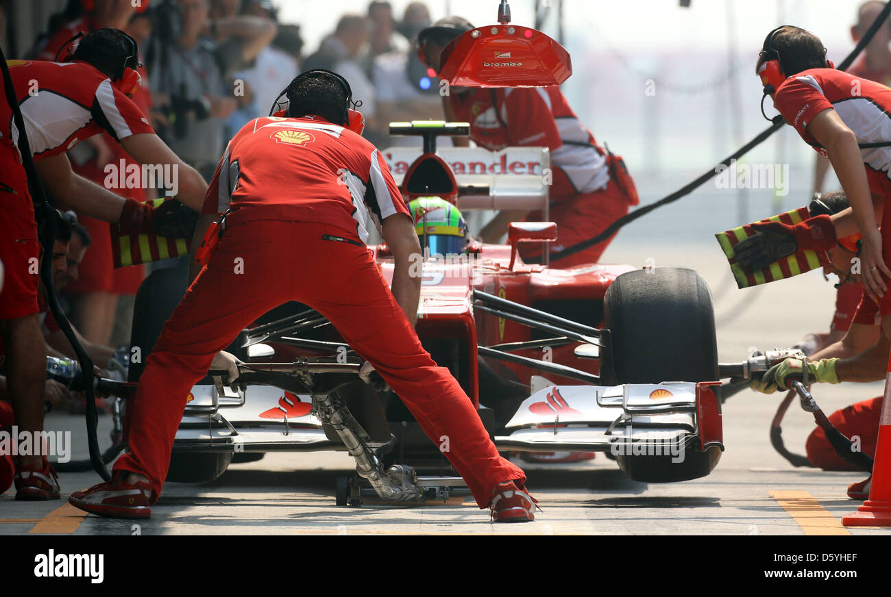 Brazilian Formula One driver Felipe Massa of Ferrari exercises pit stop ...
