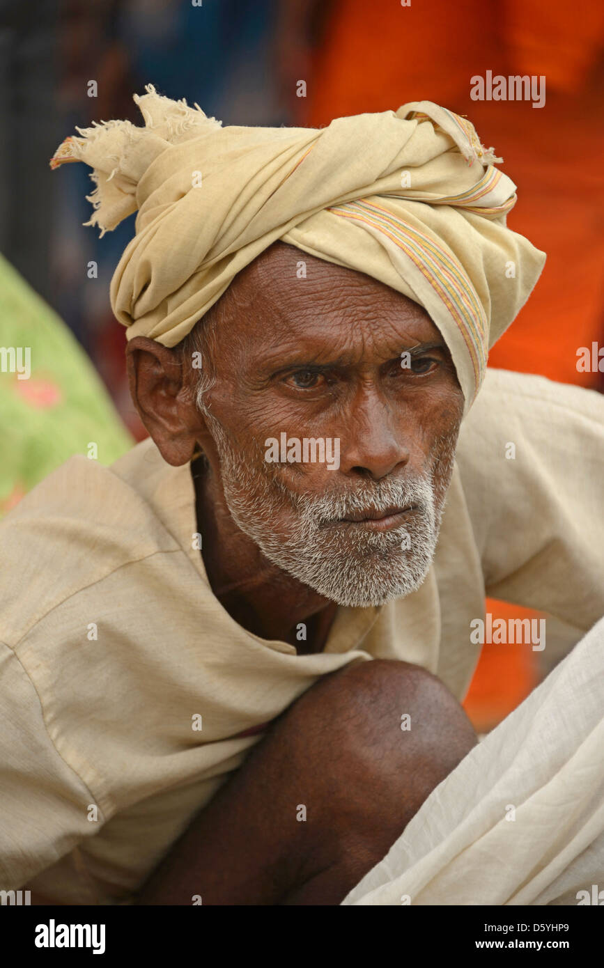 A Hindu man squatting outside the Red Fort in Old Delhi, India Stock ...
