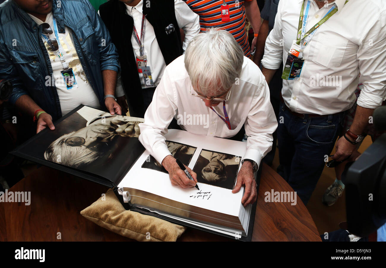 British Formula One Boss Bernie Ecclestone receives a large photo book ...
