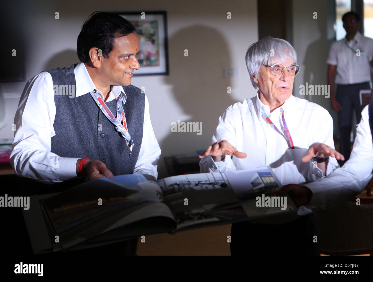 British Formula One Boss Bernie Ecclestone (R) receives a large photo ...