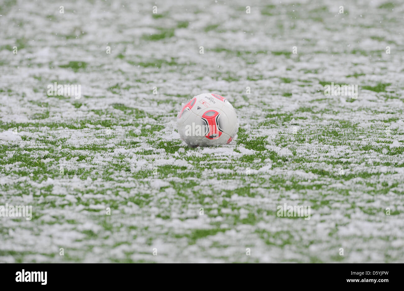 A soccer ball sits on the pitch covered in snow before the German ...