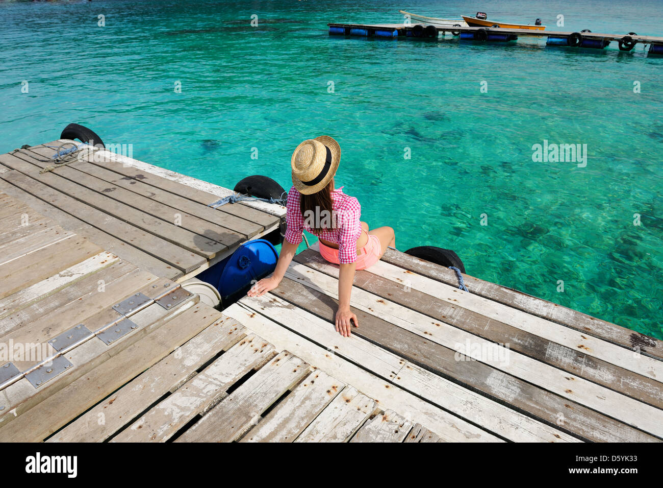 Woman at beach jetty Stock Photo - Alamy