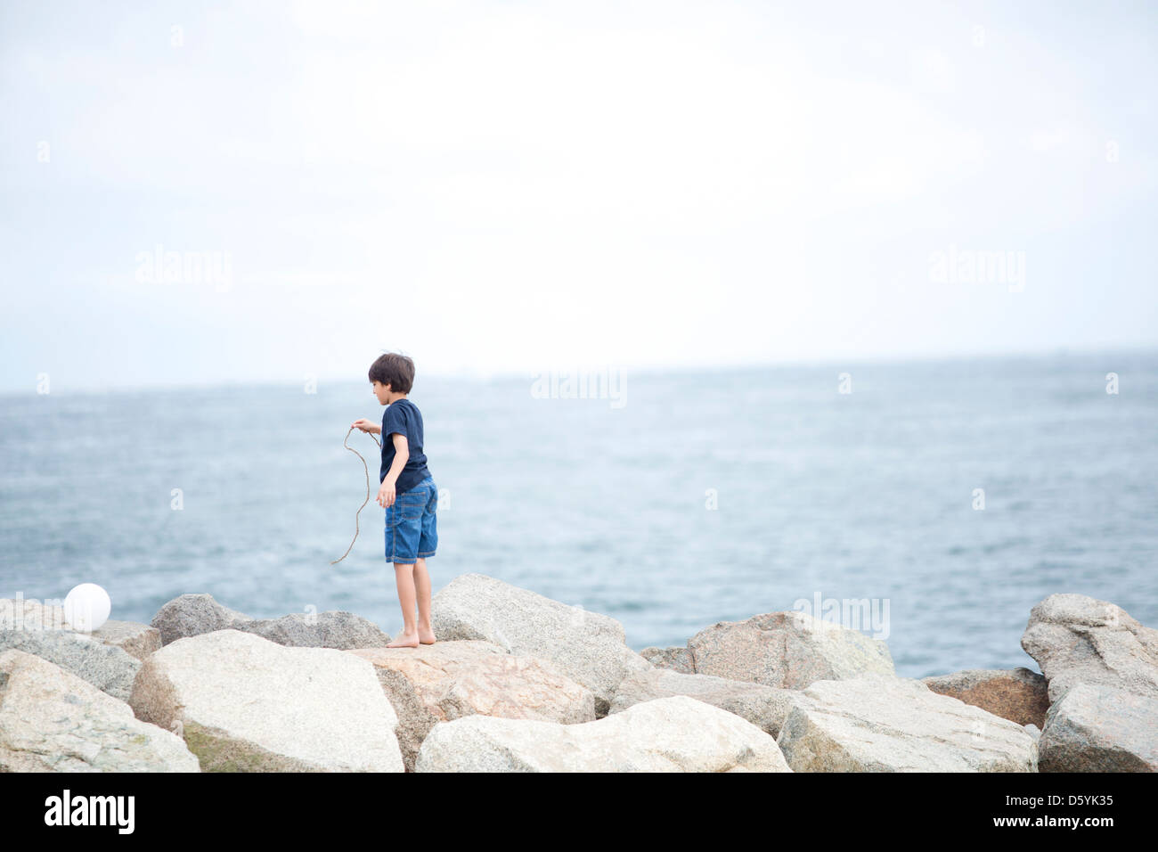 8 9 standing on rock by sea hi-res stock photography and images - Alamy