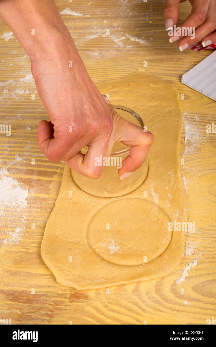 Rolled out piece of dough being cut out to make bagels Stock Photo - Alamy
