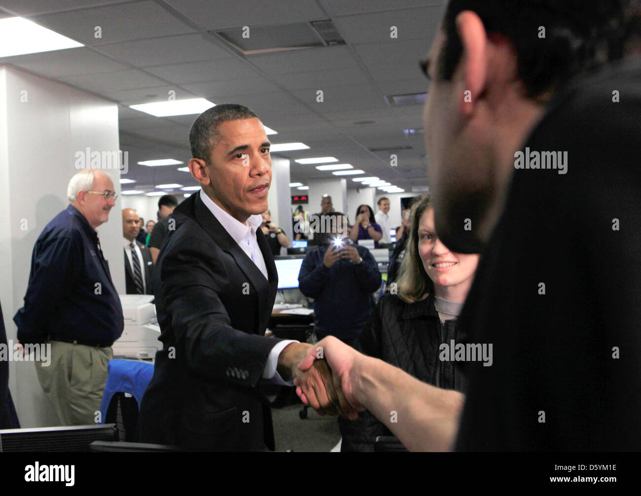 United States President Barack Obama talks to workers at FEMA ...