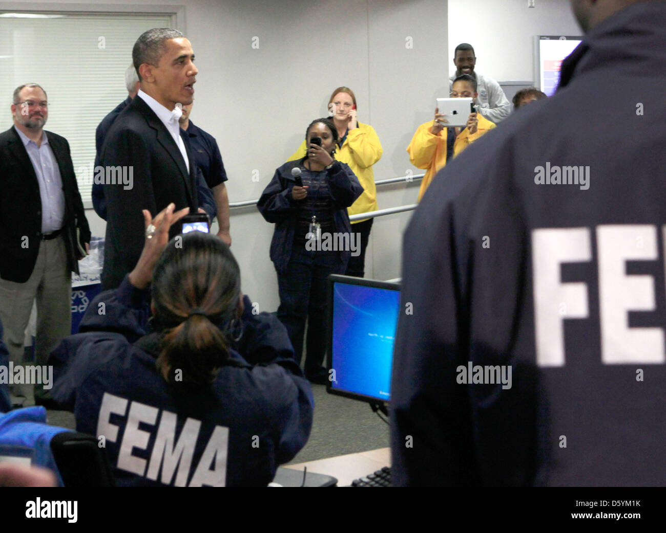United States President Barack Obama talks to workers at FEMA ...