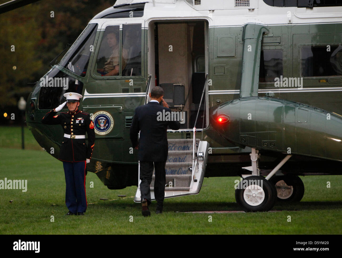 United States President Barack Obama salutes the Marine Guard as he ...