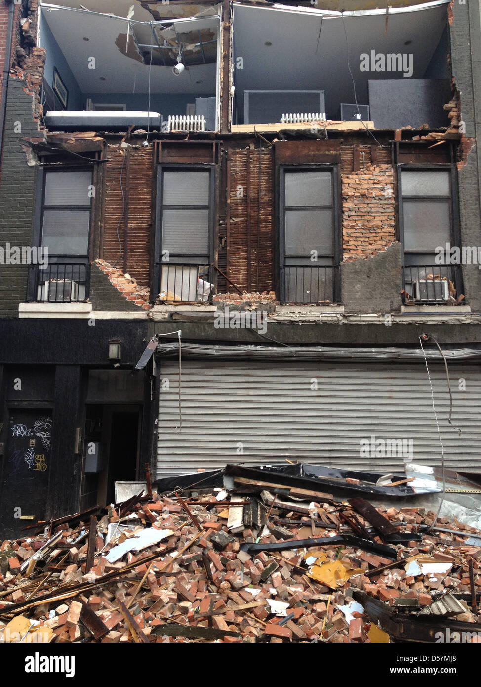 The collapsed facade of an apartment building is pictured in Lower ...