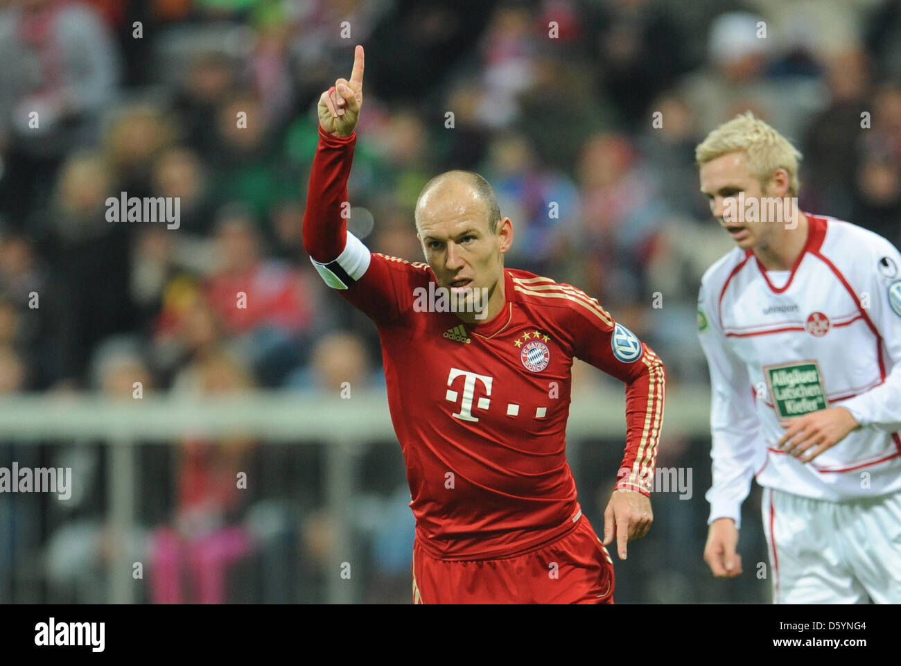 Bayern's Arjen Robben runs past Kaiserslautern's Leon Jessen (R) during ...