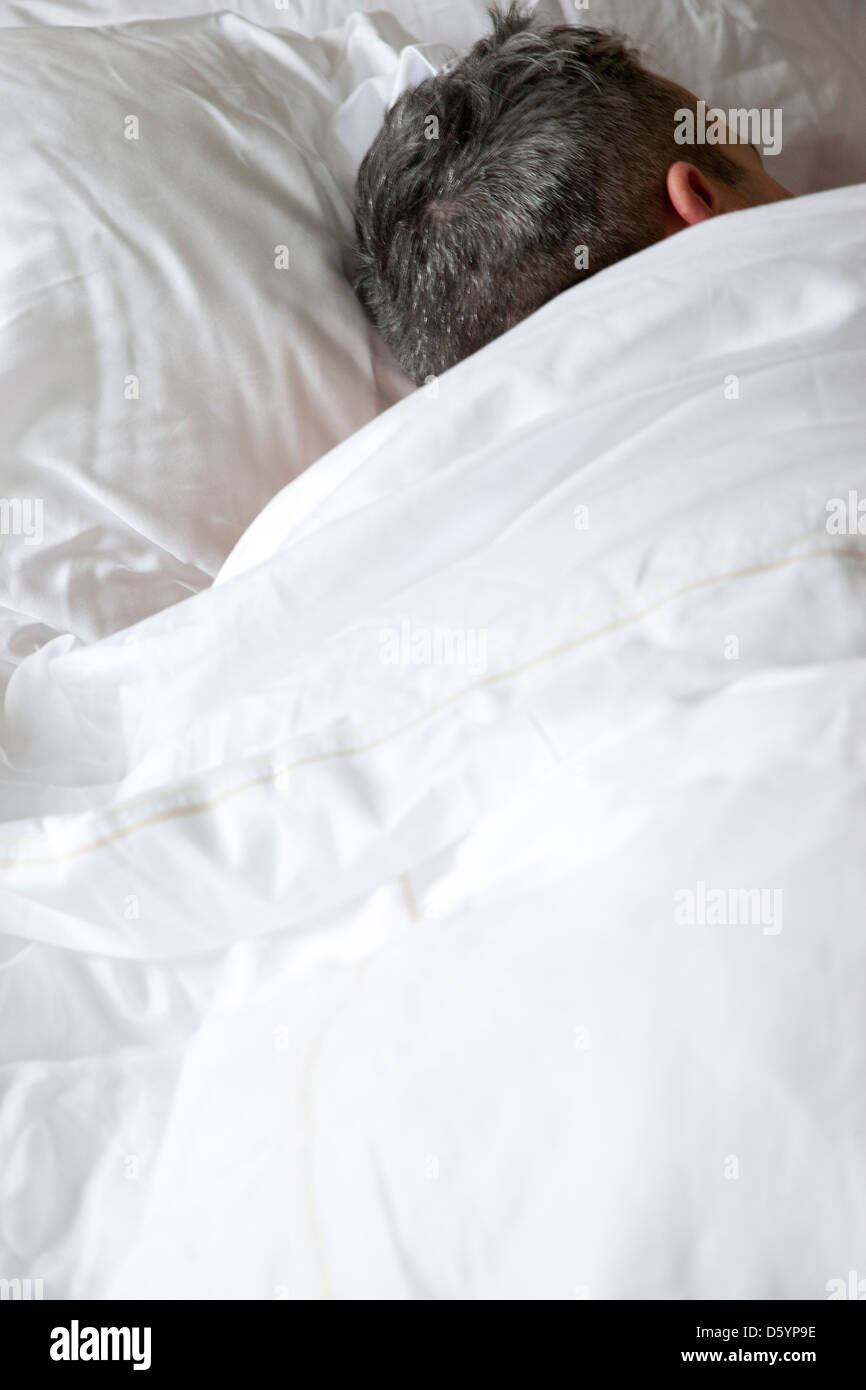 Back View of Man Sleeping in Bed Stock Photo - Alamy