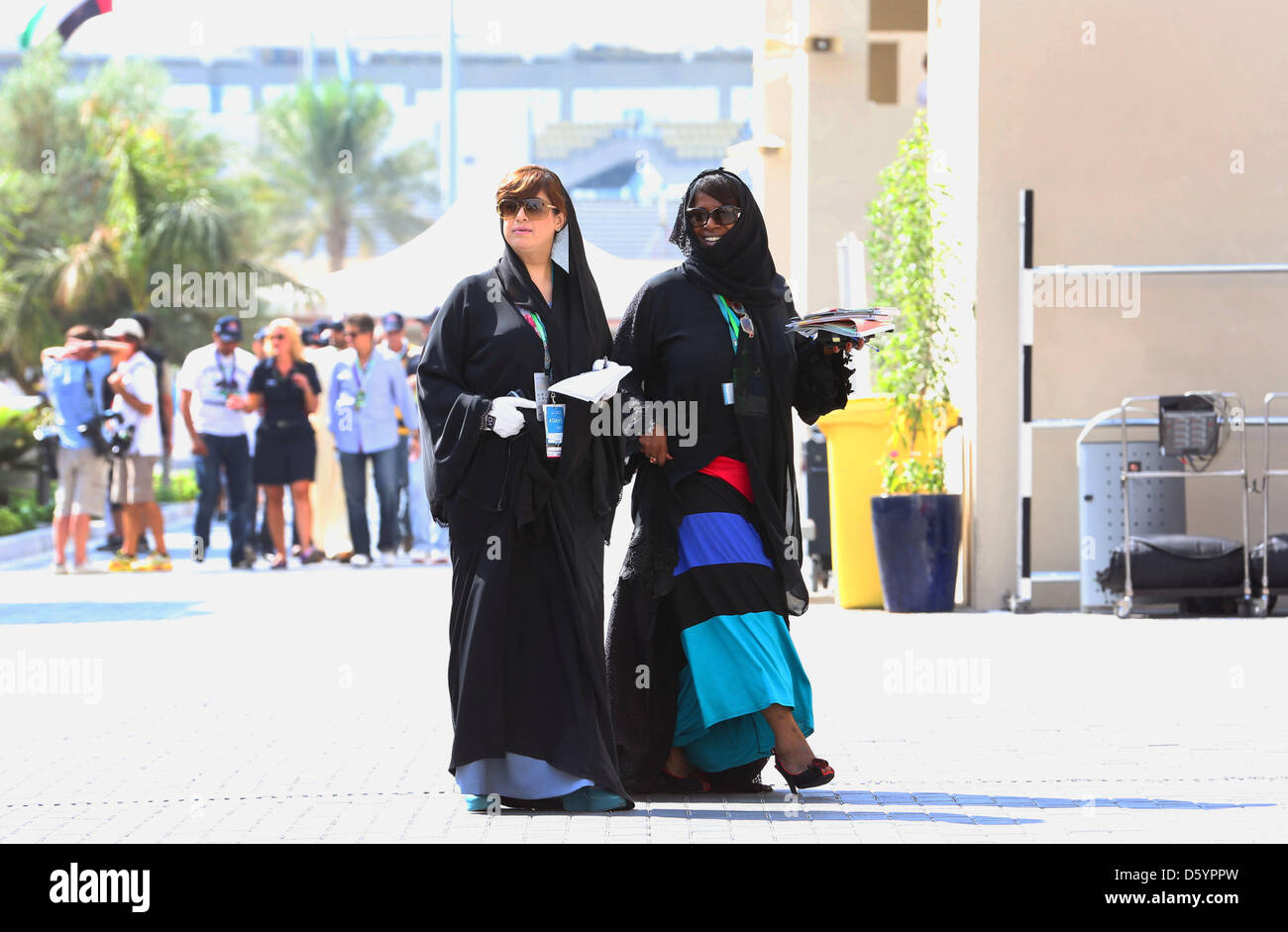 Two women walk through the paddock at Yas Marina Circuit in Abu Dhabi ...