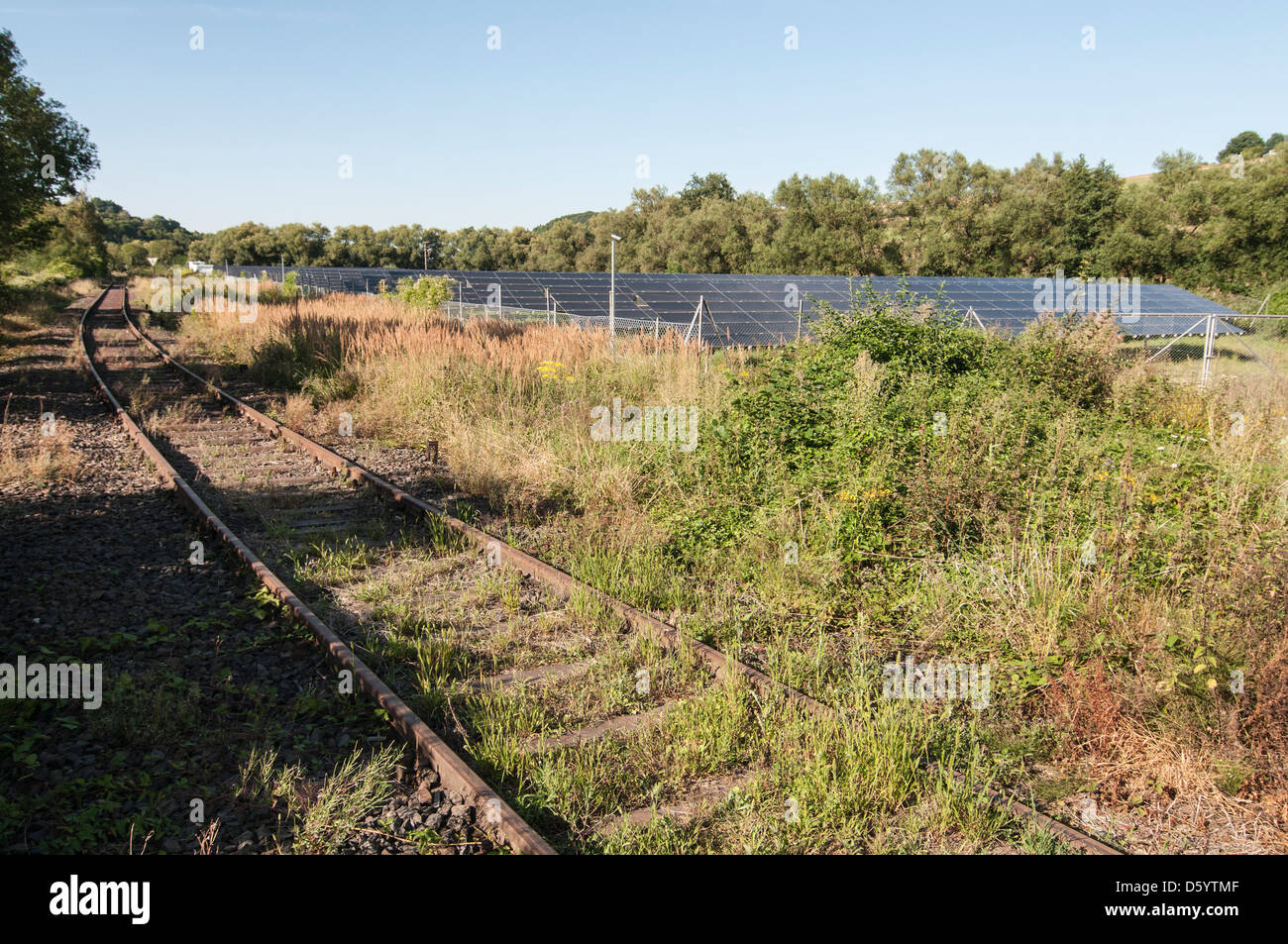 Railway track and solar field Stock Photo - Alamy