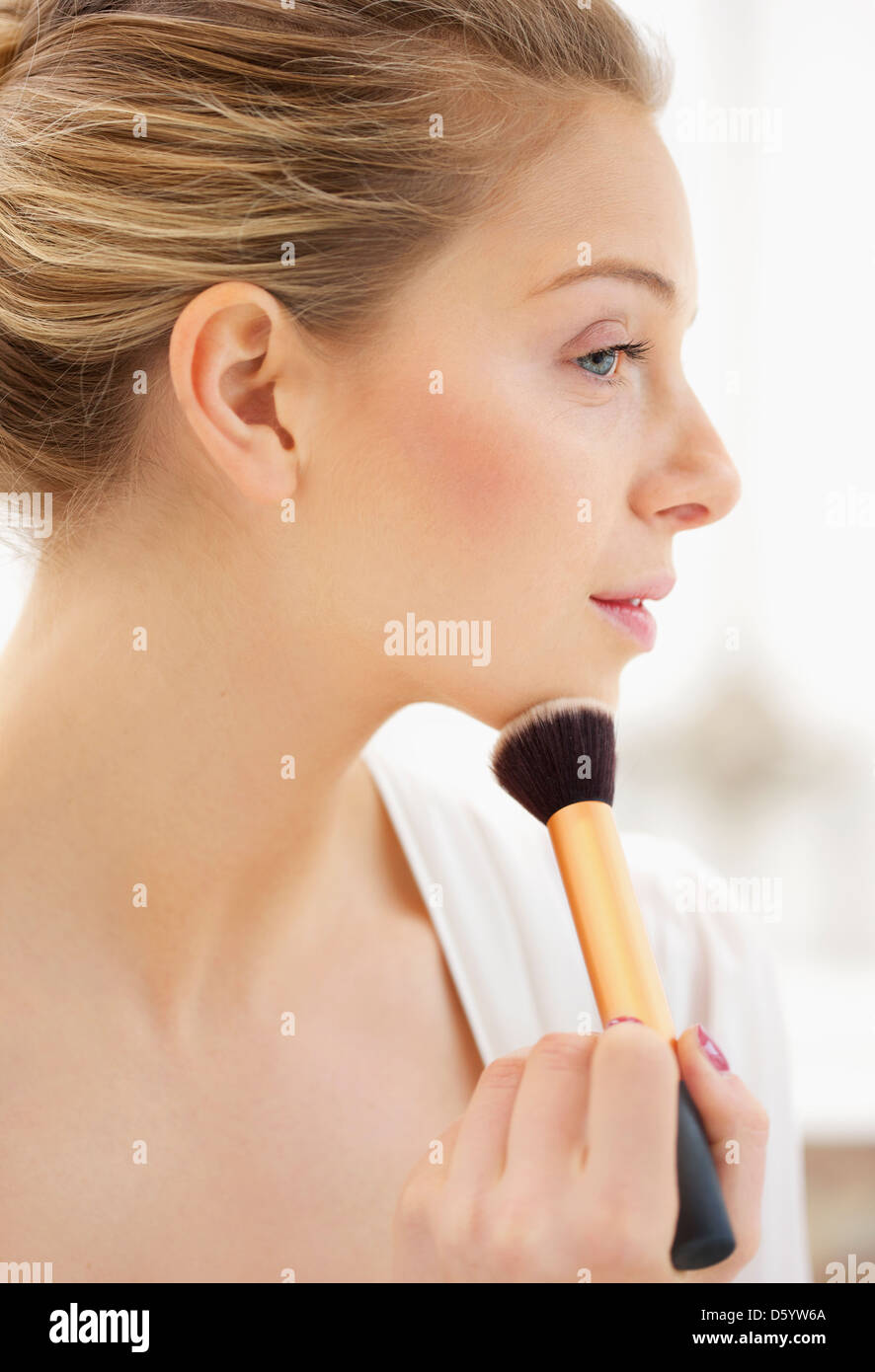Woman using blusher brush hi-res stock photography and images - Alamy