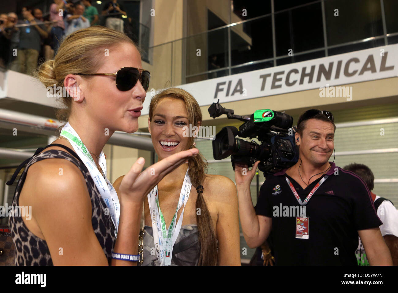 Girls pose in the pit lane after the qualification session at the Yas ...