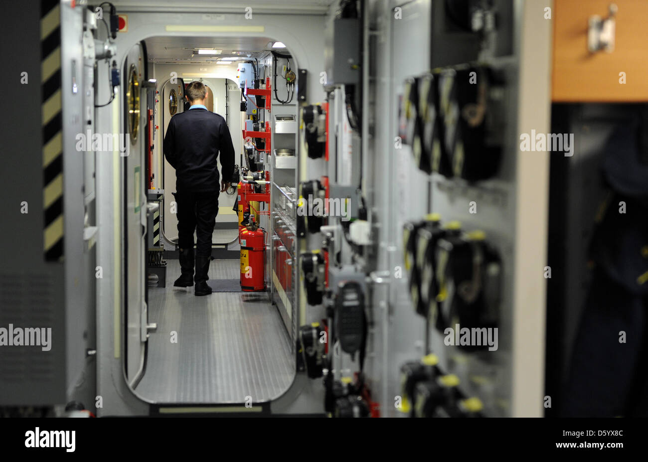 A recruit walks down a corridor of the corvette 'Braunschweig' at the ...