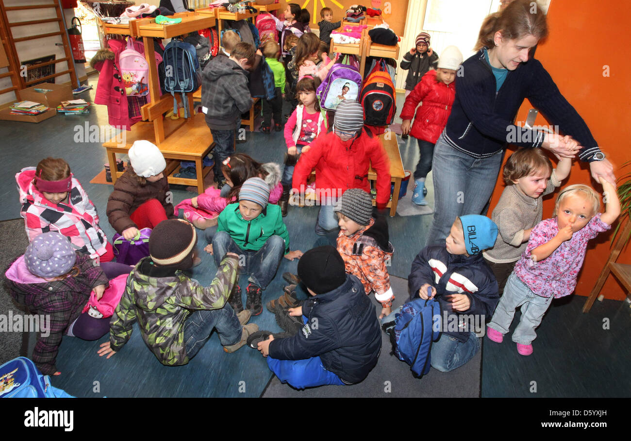 Children get dressed for playing in the garden at the Kindergarten ...