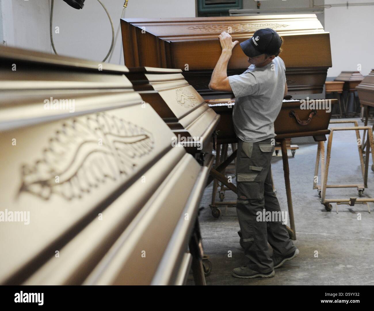 Staff members of the coffin factory Wurth work on coffins in Kappel ...