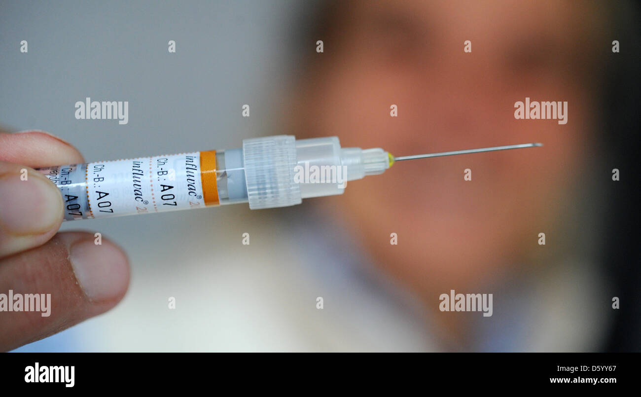 Illustration - A doctor holds a syringe containing the substance ...