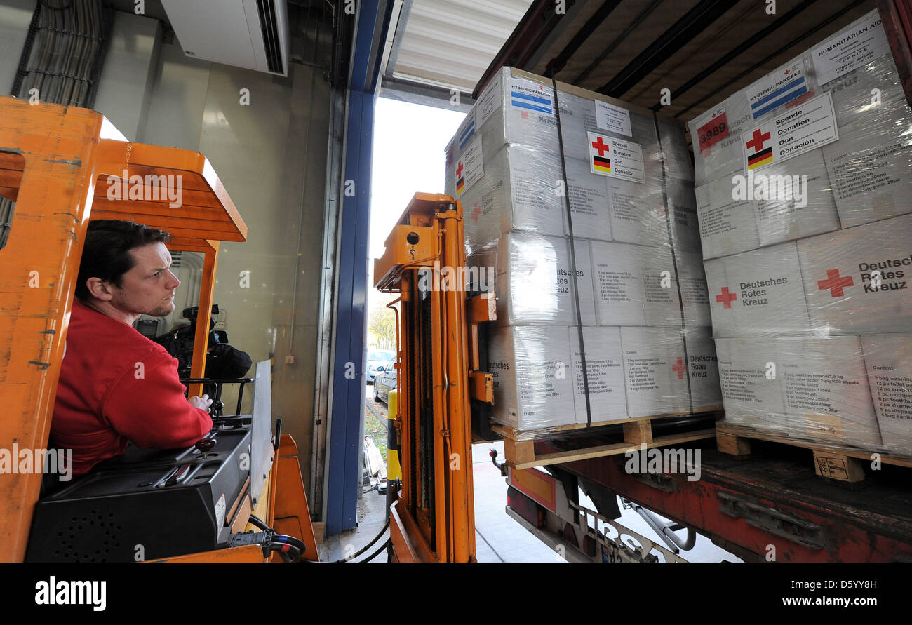 A German Red Cross employee loads first humanitarian aid parcels for ...