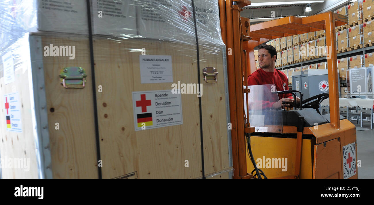 A German Red Cross employee loads first humanitarian aid parcels for ...