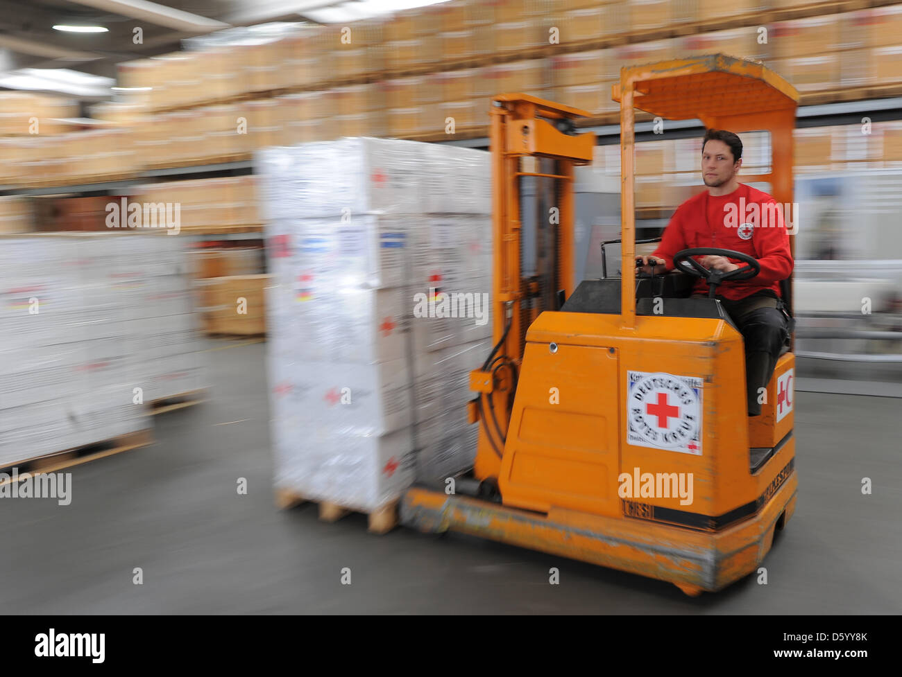 A German Red Cross employee loads first humanitarian aid parcels for ...