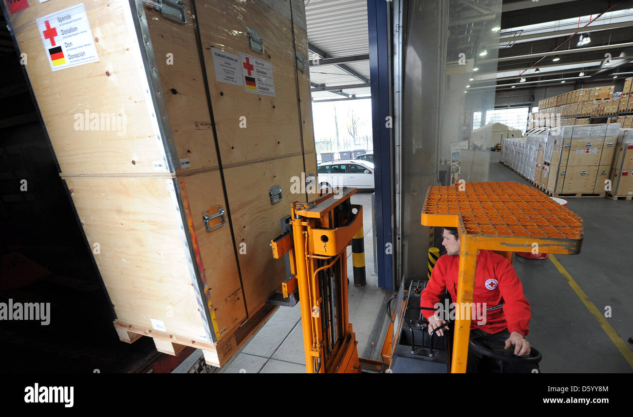 A German Red Cross employee loads first humanitarian aid parcels for ...