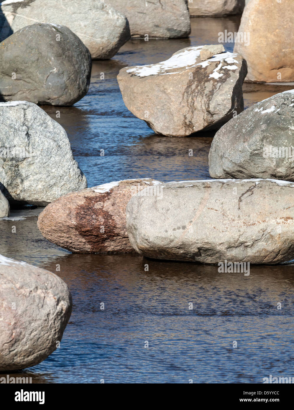 Stones with snow in shallow spring stream Stock Photo - Alamy