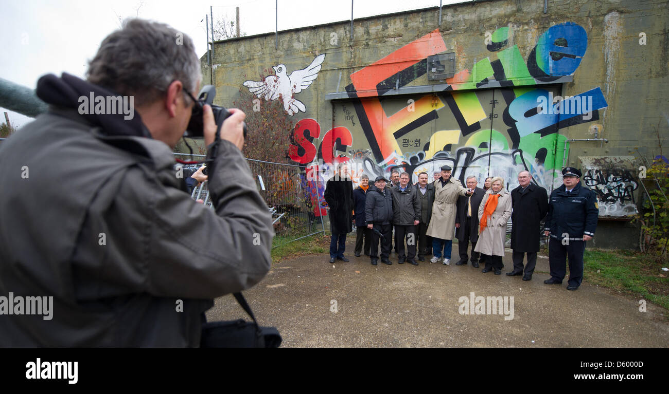 Contemporary witnesses pose in front of a bunker on the former military ...