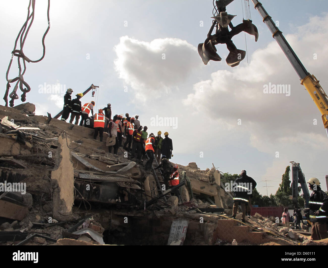 Rescue workers search for survivors in the rubble of the Melcom ...