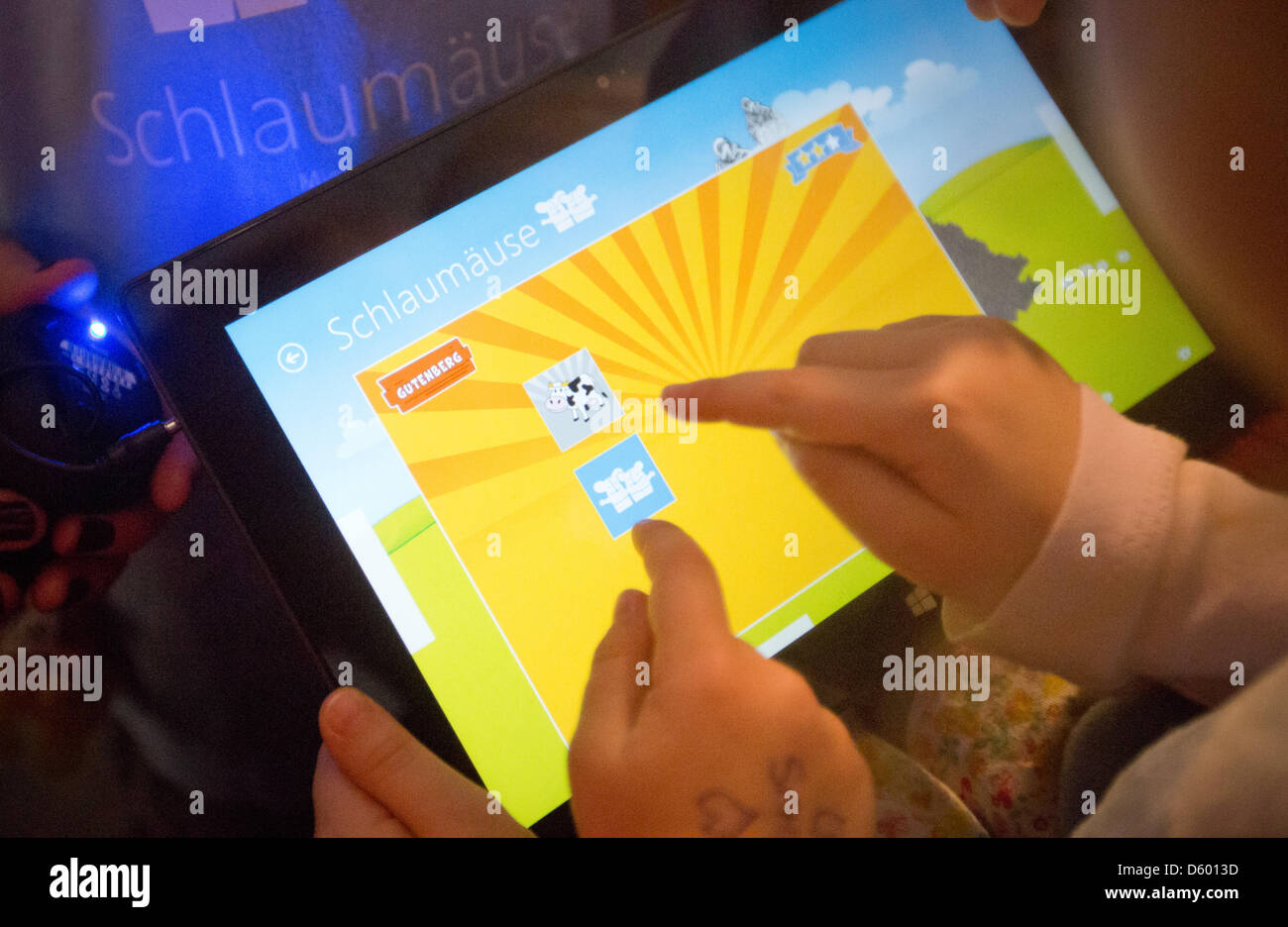 Children play with a Microsoft table computer during the unveiling of ...