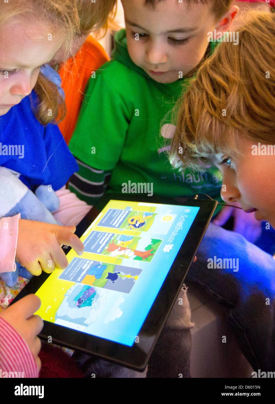 Children play with a Microsoft table computer during the unveiling of ...