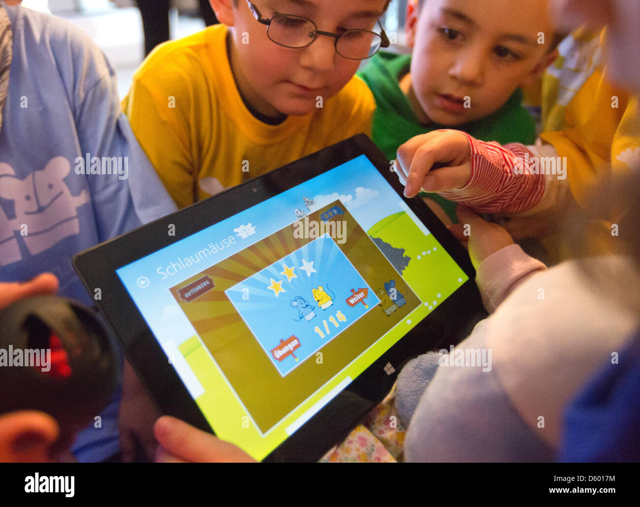 Children play with a Microsoft table computer during the unveiling of ...