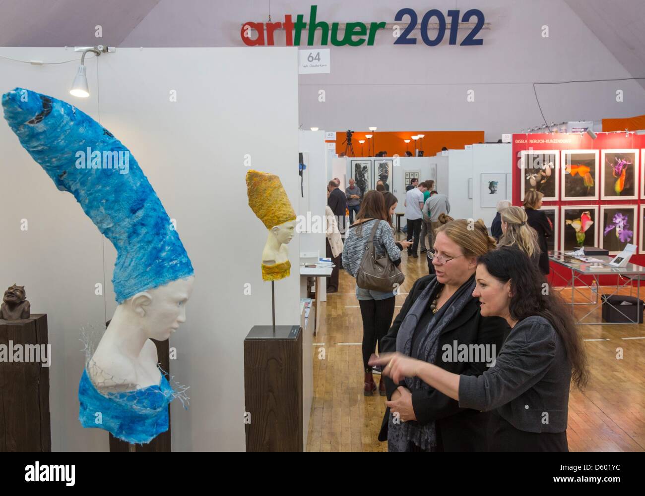 Visitors look at sculptures by Claudia Katrin Leyh during the art fair ...