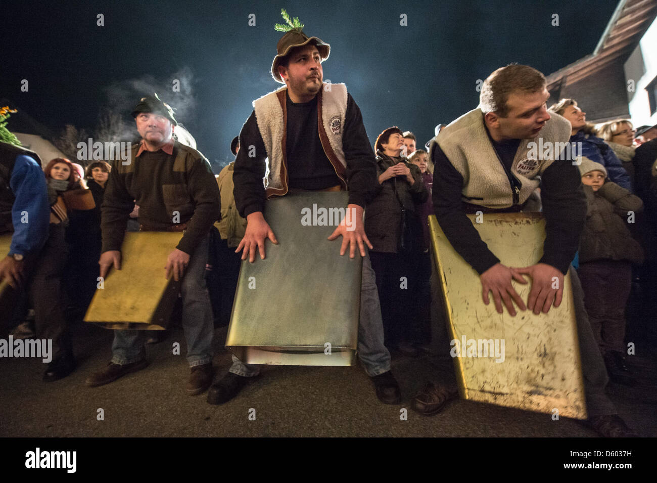 Participants in the traditional 'Wolfauslassen' ring oversized cow ...