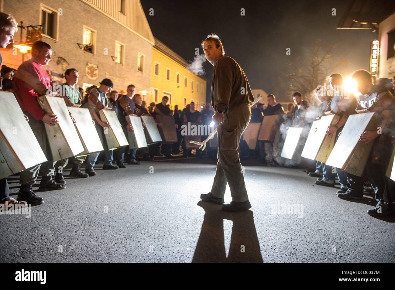 Participants in the traditional 'Wolfauslassen' ring oversized cow ...
