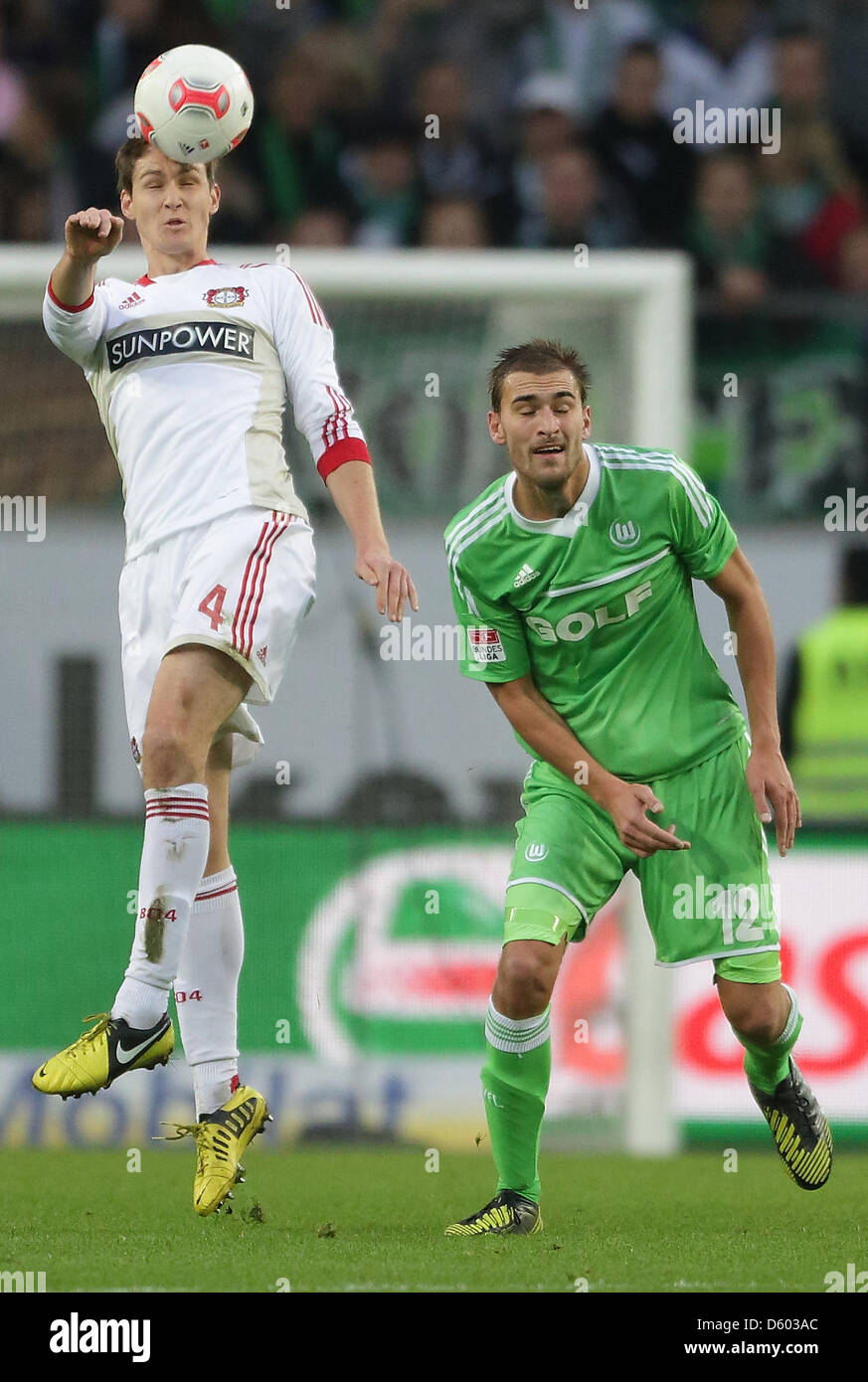 Wolfsburg's Bas Dost (R) and Leverkusen's Philipp Wollscheid vie for ...