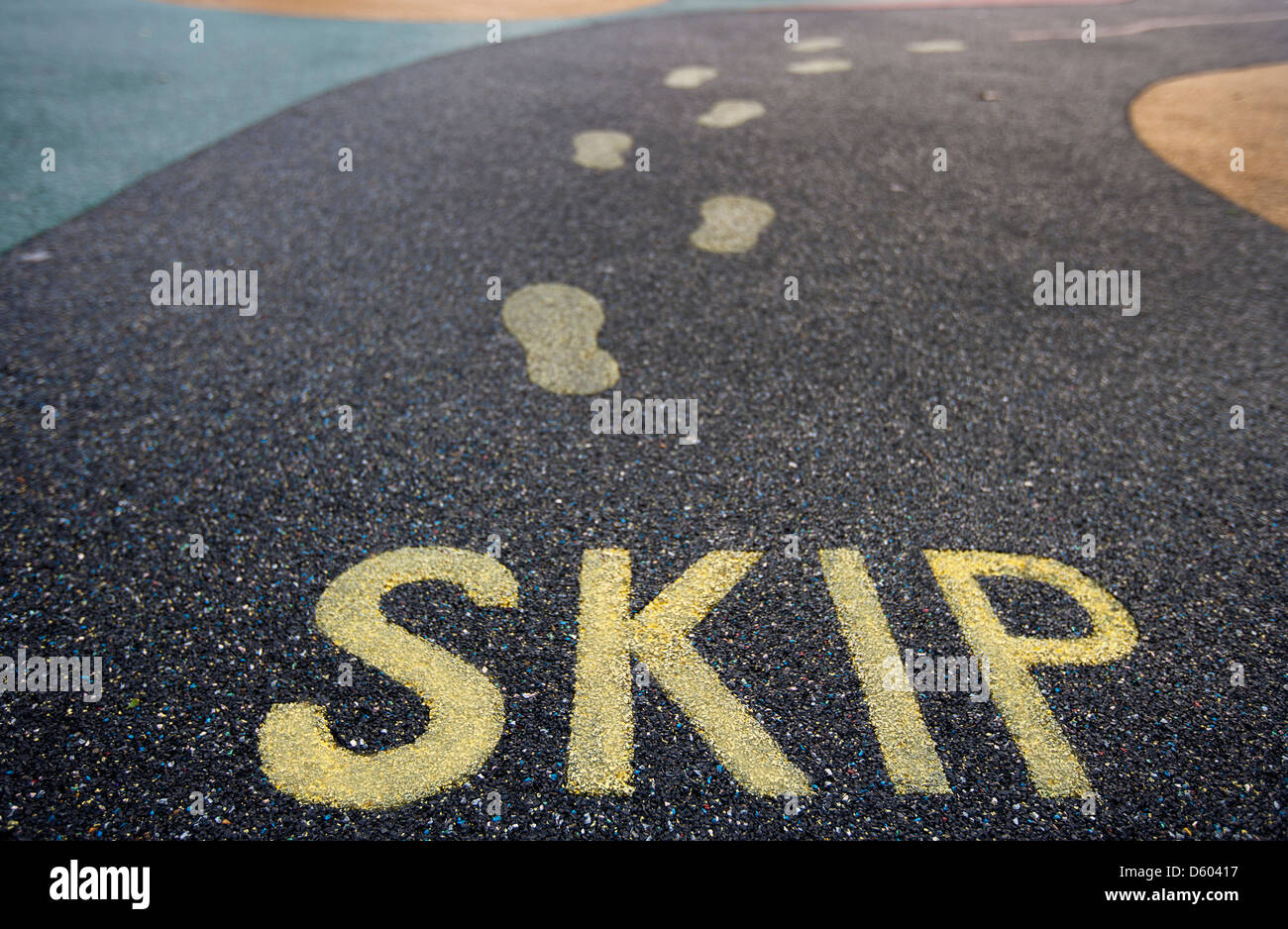 "Skip" written into rubber flooring of children's playground Stock ...