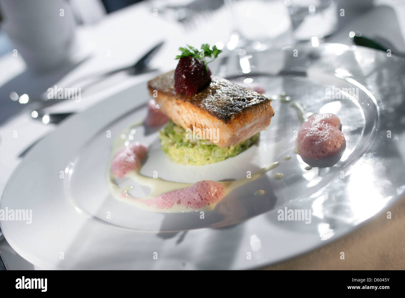 Pan-Fried Salmon with foam on a round white plate Stock Photo - Alamy