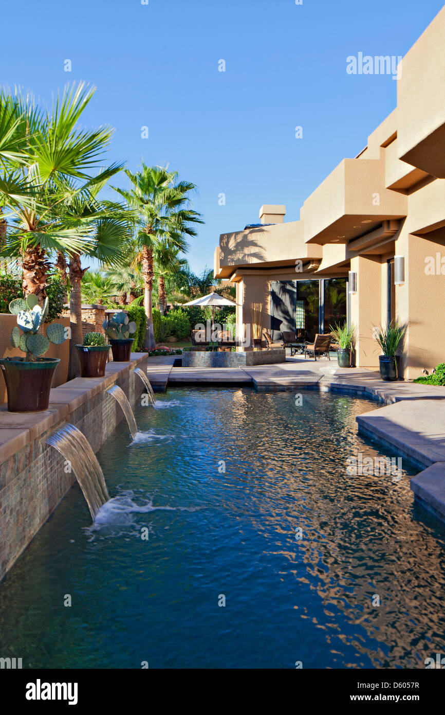 Luxury Villa with waterfall feature palm trees Stock Photo - Alamy
