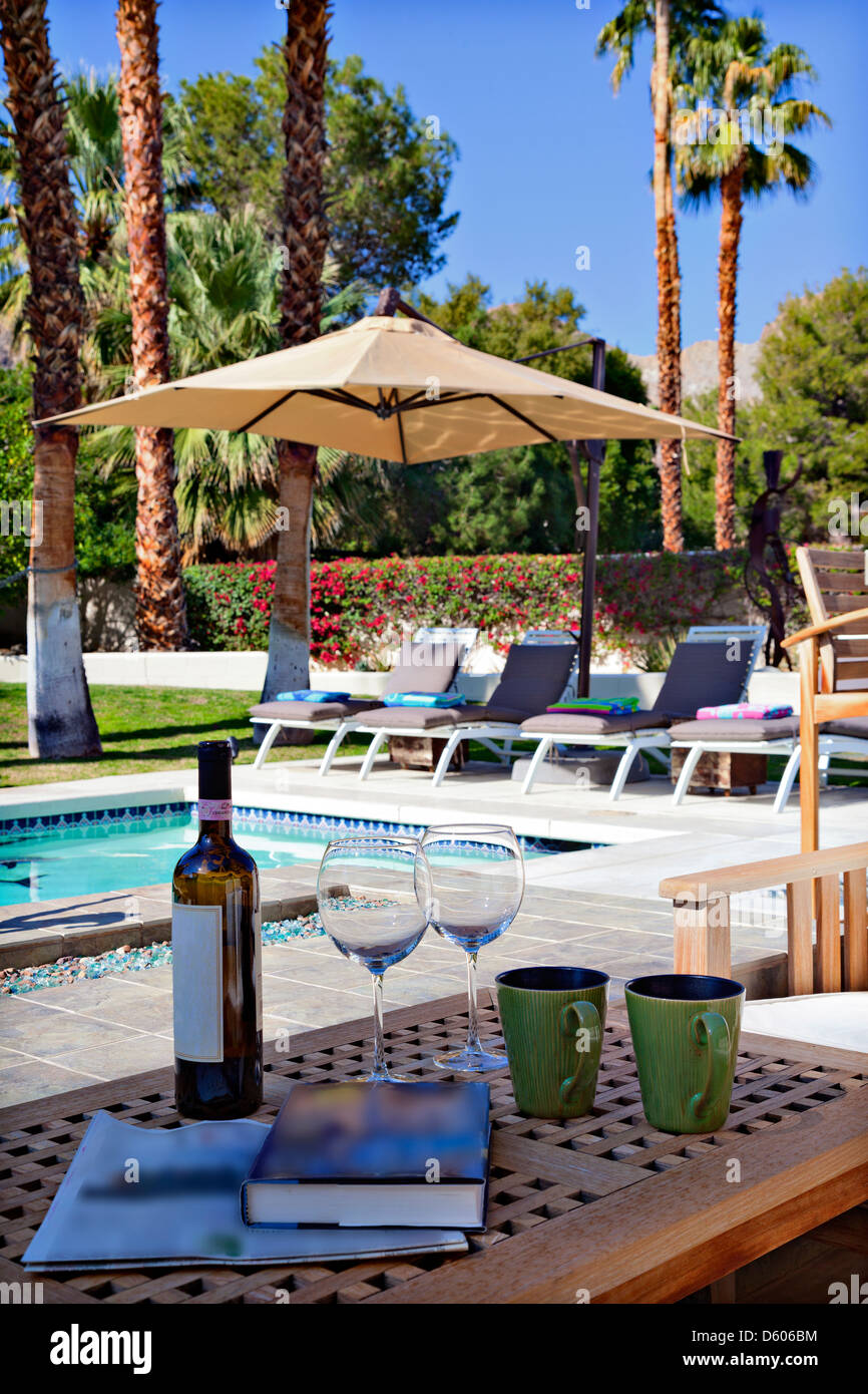 Wine and wineglasses by poolside Stock Photo - Alamy