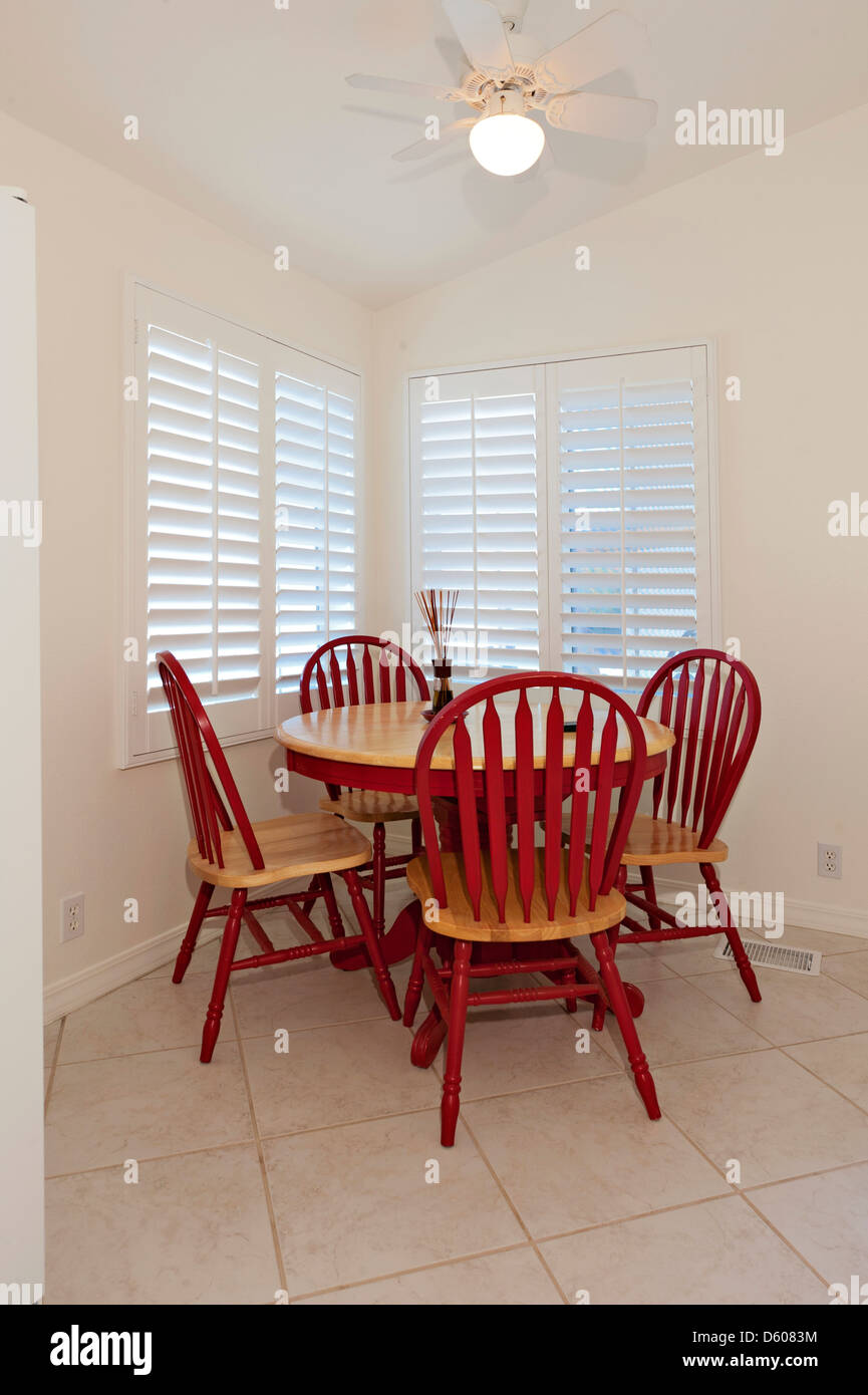 Wooden dining table with red chairs Stock Photo - Alamy
